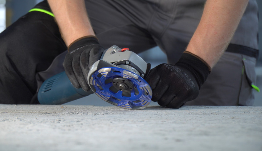 Grinding of construction materials with an angle grinder.
